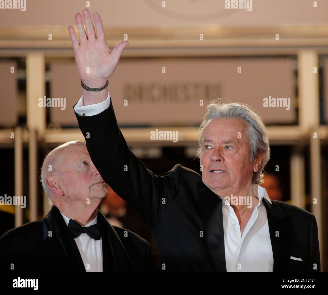 Actor Alain Delon, right, waves as festival director Gilles Jacob looks ...