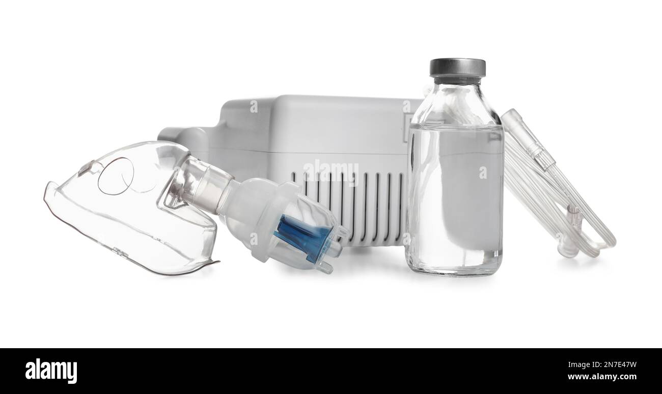 Modern nebulizer with face mask and liquid medicine on white background ...