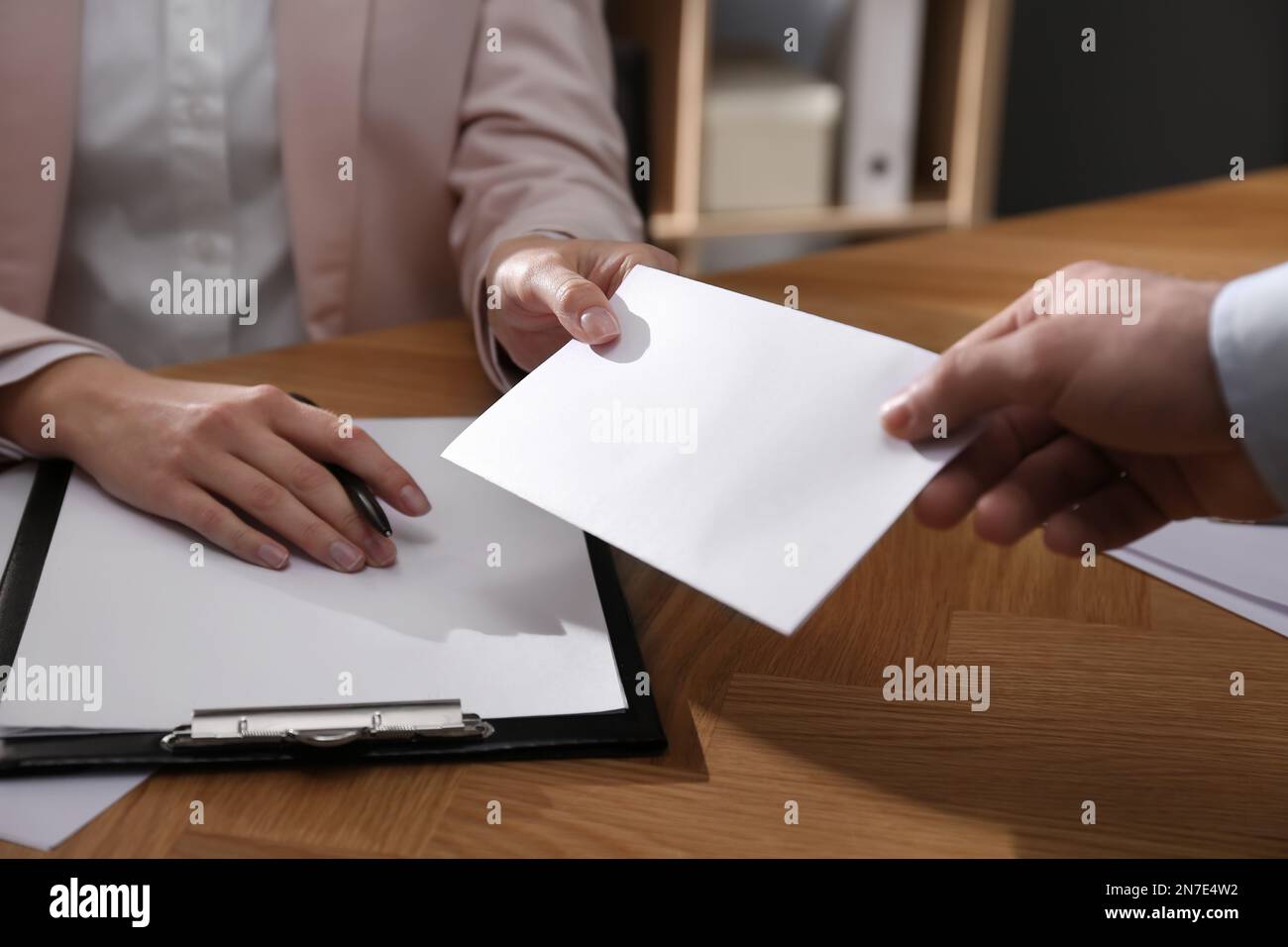 Employee giving resignation letter to boss in office, closeup Stock ...