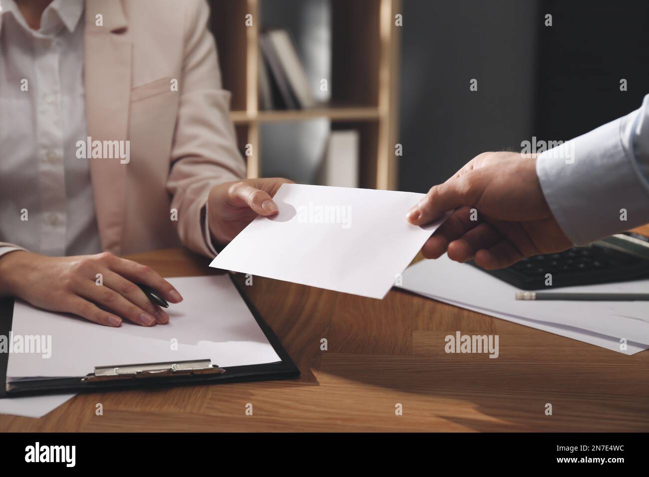 Employee giving resignation letter to boss in office, closeup Stock ...