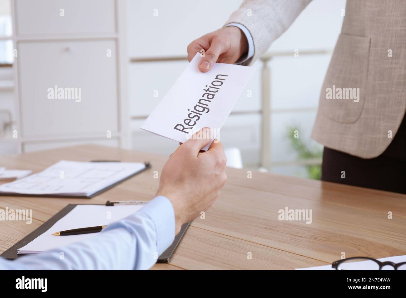 Employee giving resignation letter to boss in office, closeup Stock ...