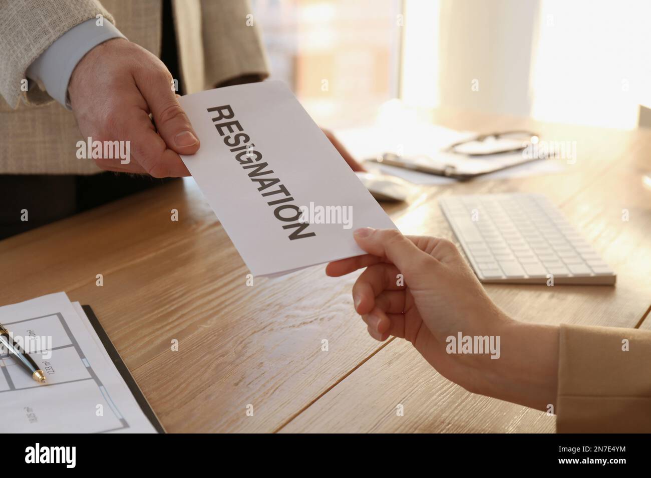 Employee giving resignation letter to boss in office, closeup Stock ...