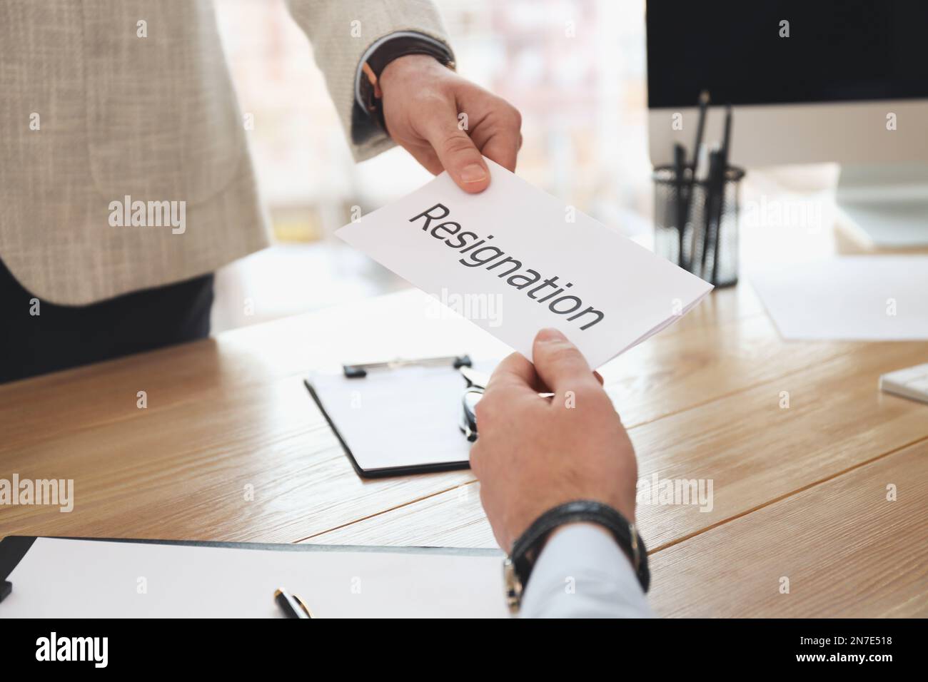 Employee giving resignation letter to boss in office, closeup Stock ...