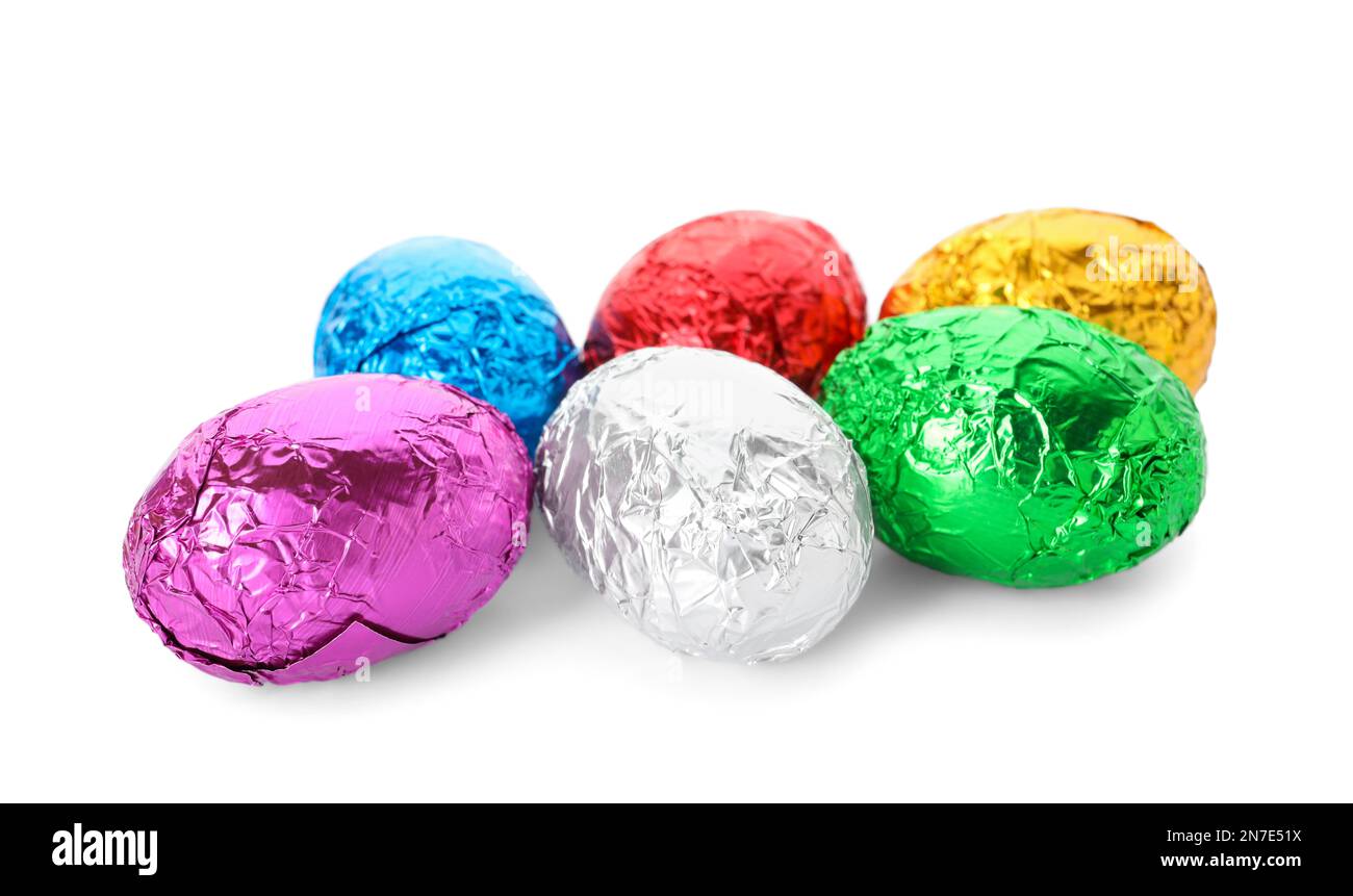 Many chocolate eggs wrapped in bright foil on white background Stock ...