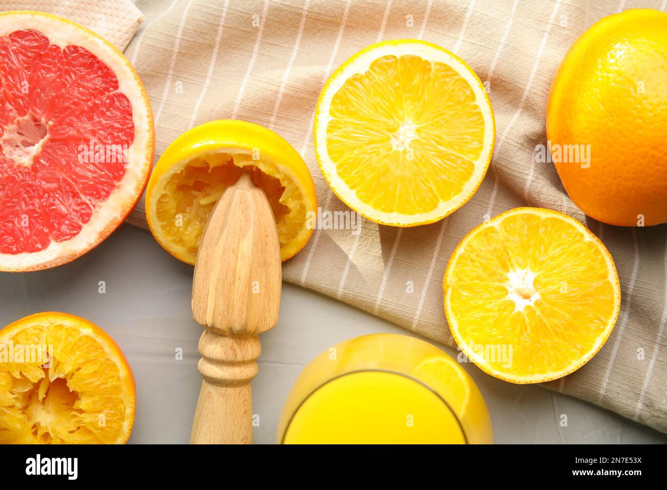 Flat lay composition with oranges and reamer on light grey table Stock ...