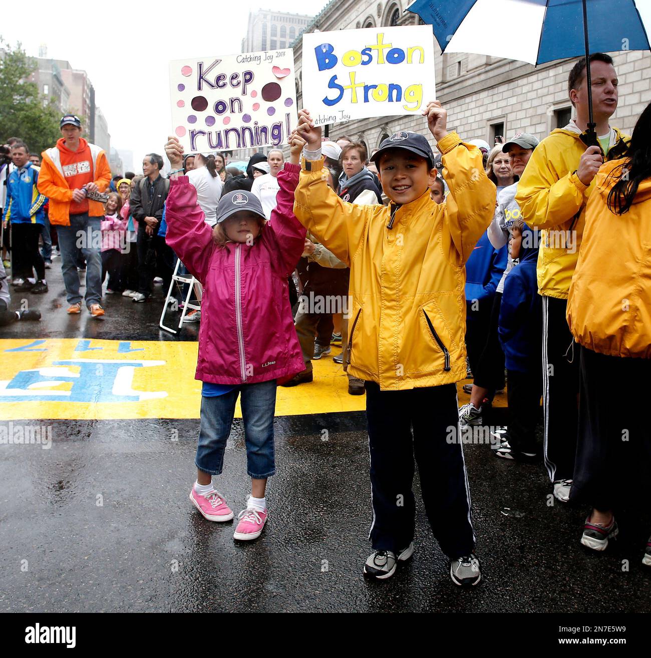 Maxwell Surprenant, right, and Emily Perron hold up signs cheering on ...
