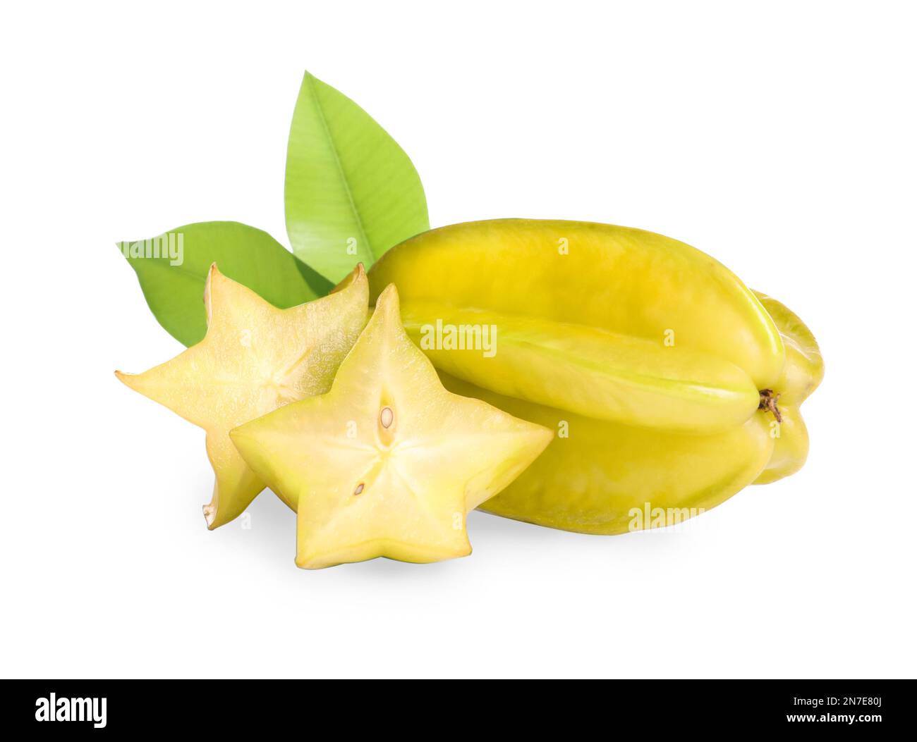 Cut and whole carambolas with green leaves on white background Stock ...