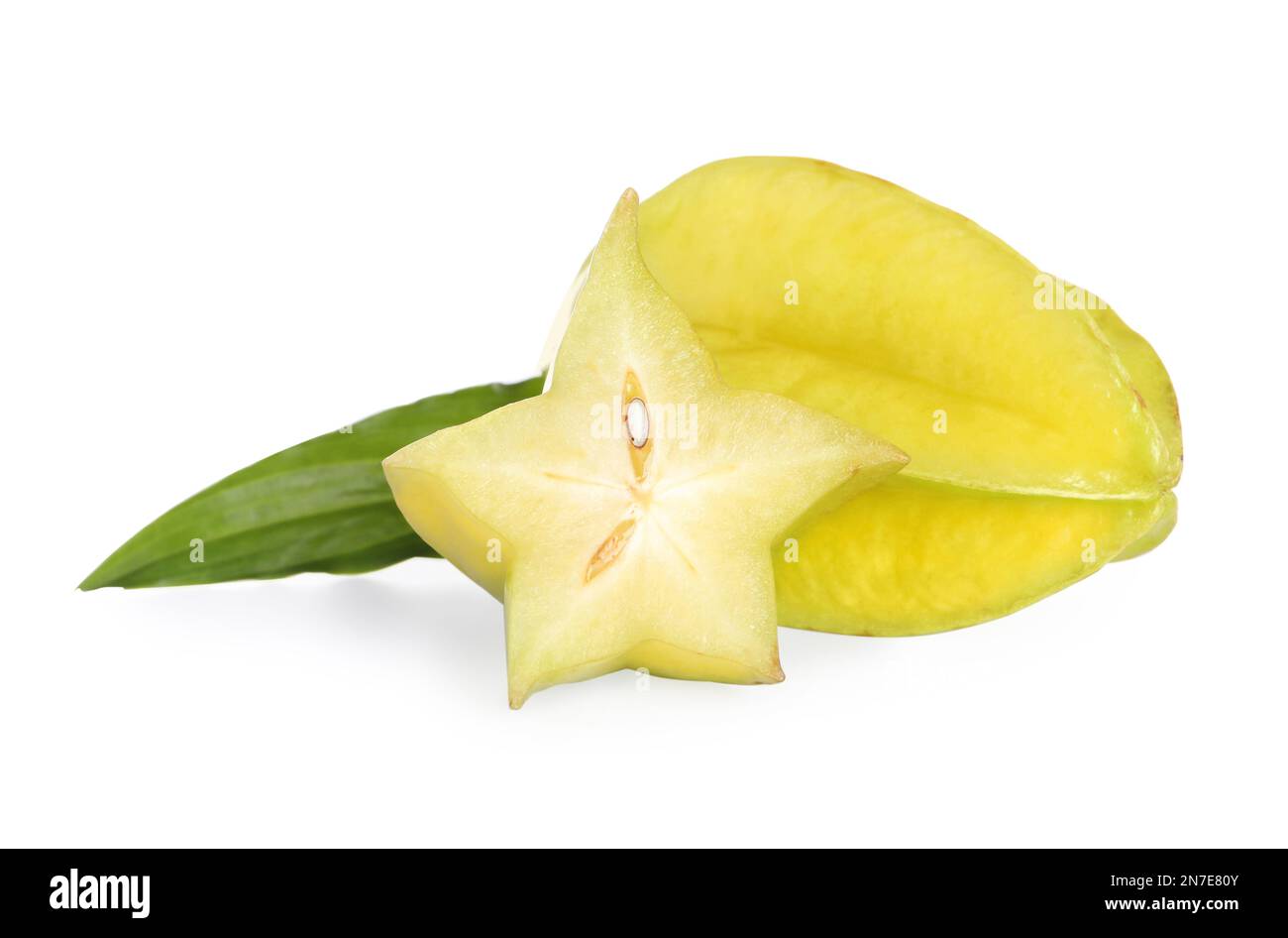 Cut and whole carambolas with green leaf on white background Stock ...