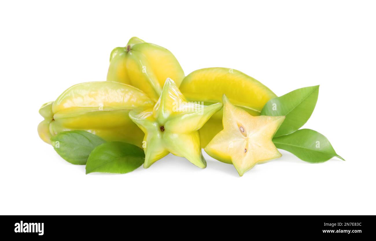 Cut and whole carambolas with green leaves on white background Stock ...