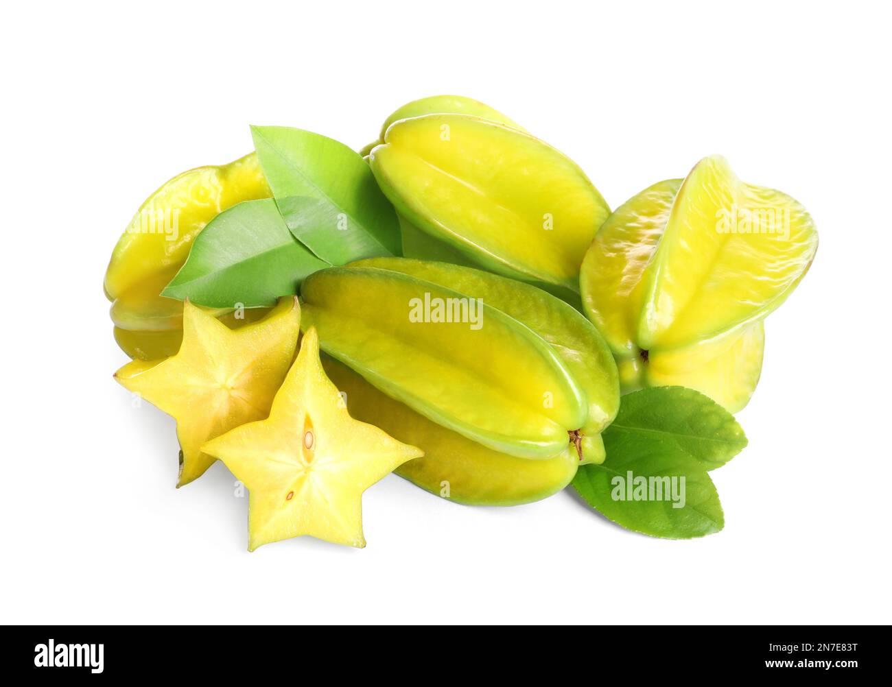 Cut and whole carambolas with green leaves on white background Stock ...