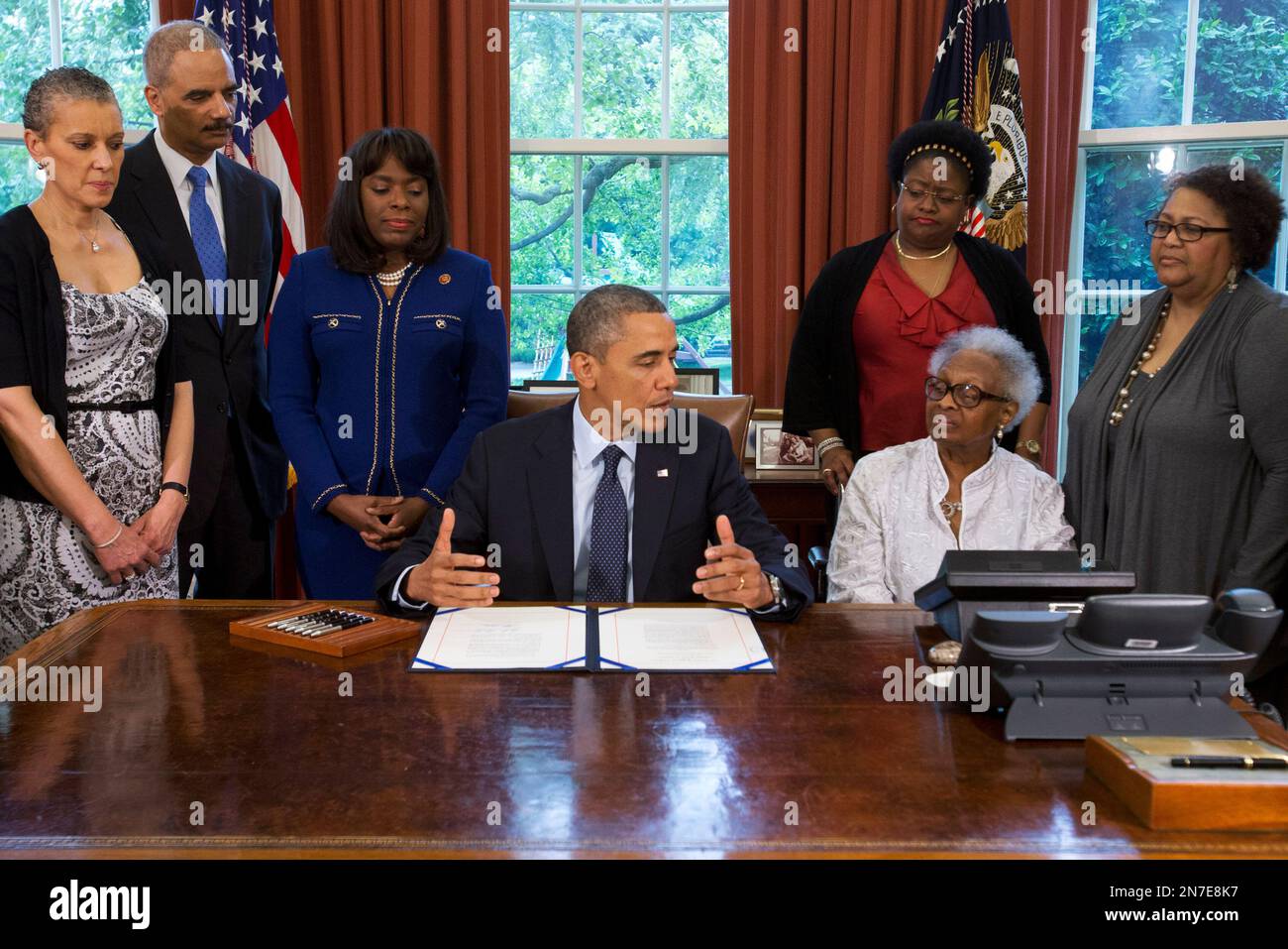 President Barack Obama looks toward family members of victims of the ...