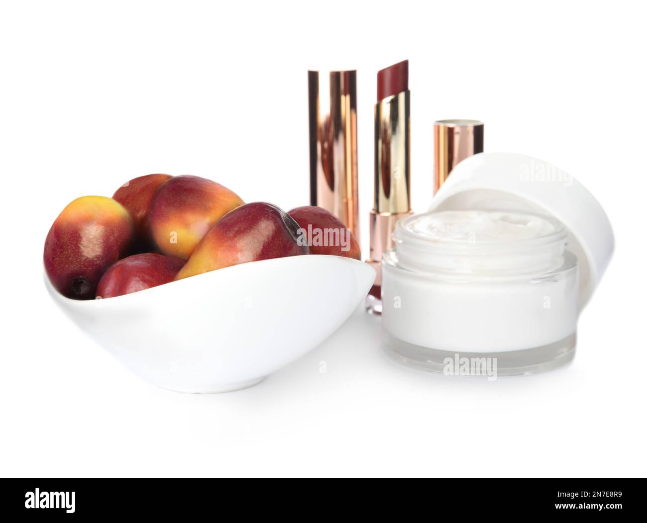 Fresh ripe palm oil fruits and cosmetic products on white background ...