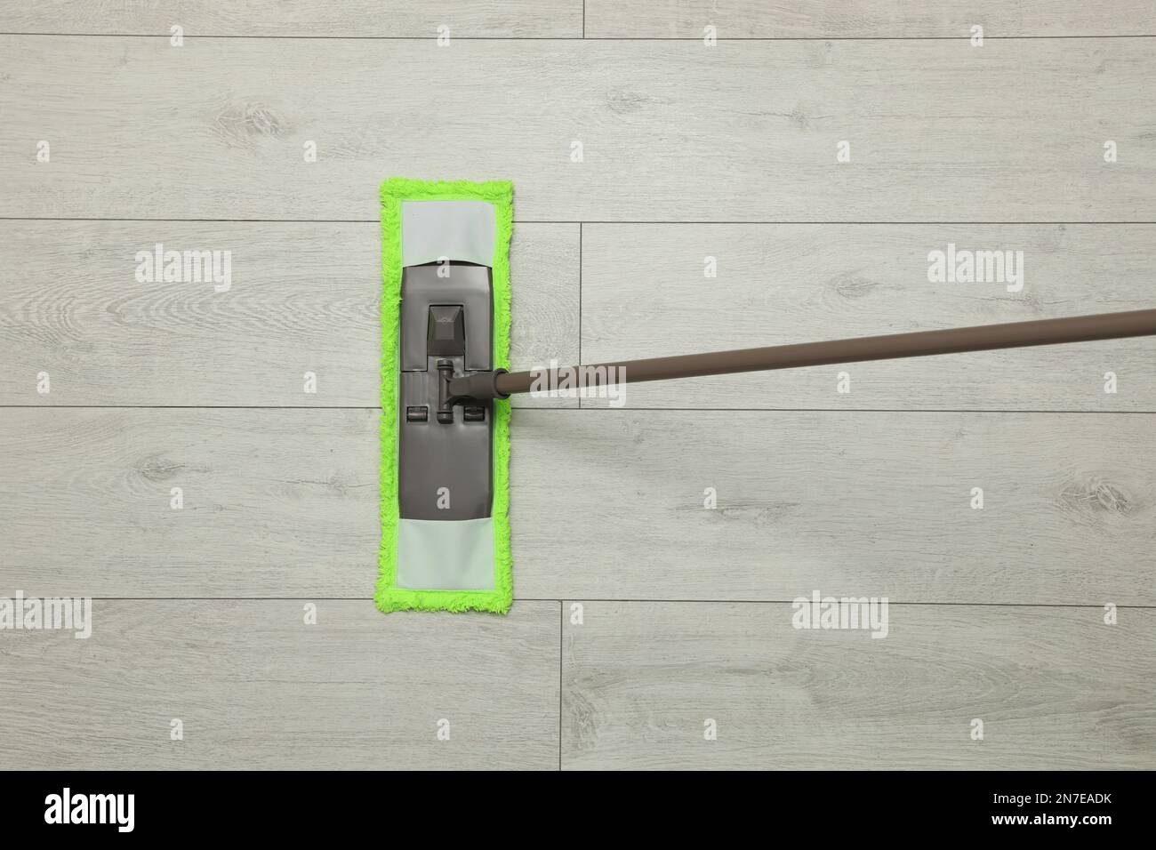 Cleaning of wooden floor with mop, top view Stock Photo - Alamy