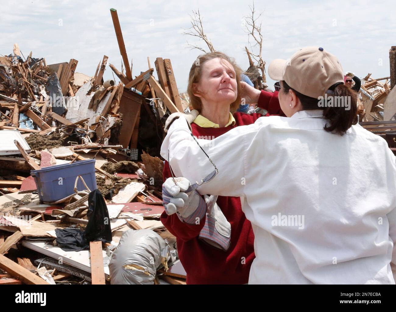 Christine Jones, left, is comforted by her cousin, Ann Worden, right ...