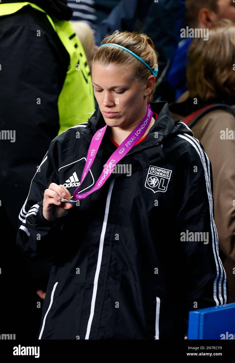 Lyon's Swiss player Lara Dickenmann look down at her runner's up medal ...