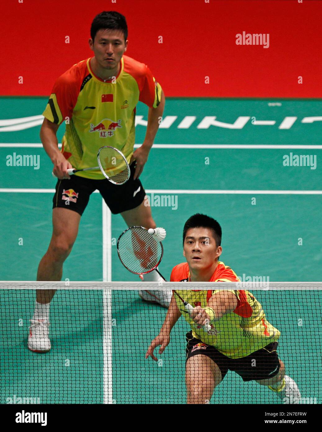 China's Fu Haifeng, front, returns a shot against Indonesia's Rian ...