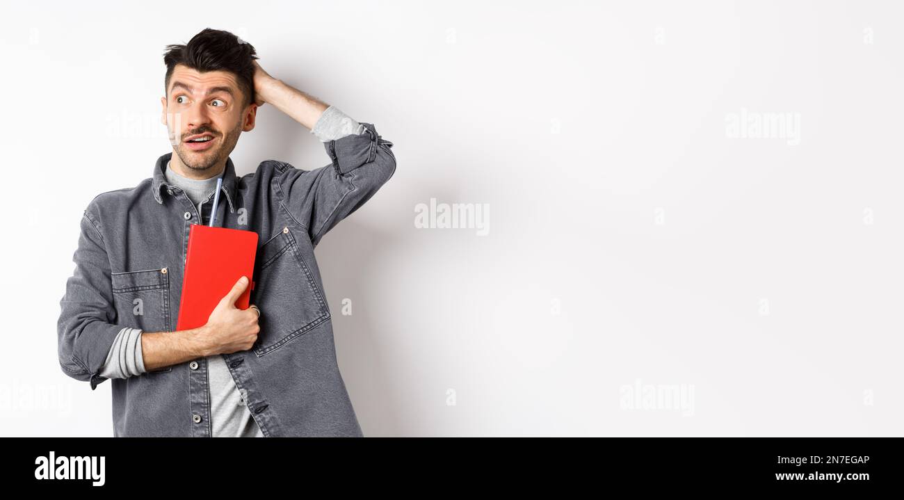 Confused guy scratch head and look aside at logo puzzled, holding red ...