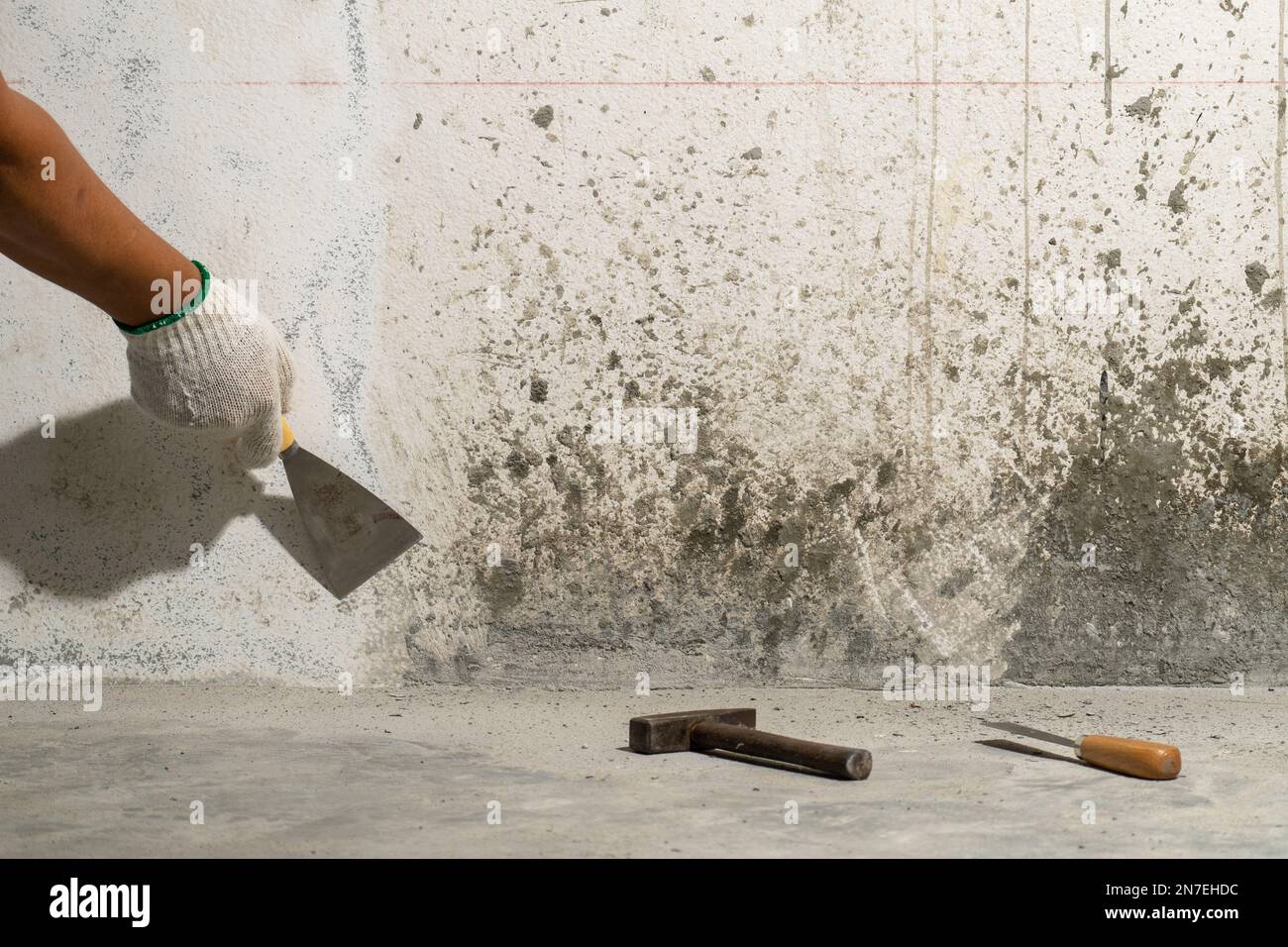 Renovation home , Painter scraping concrete debris on wall from ...