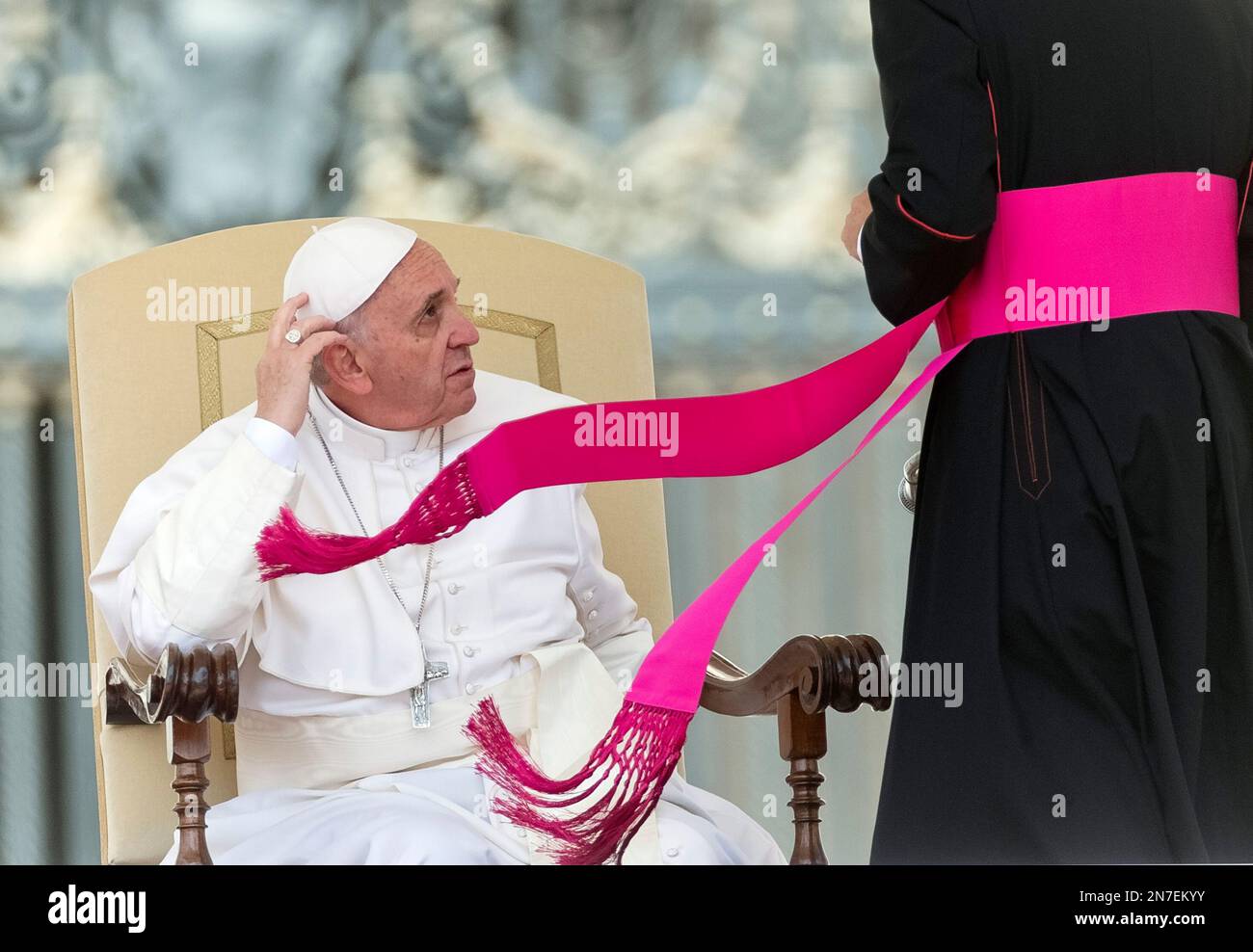 Pope Francis holds on his skull cap during a gust of wind while he ...