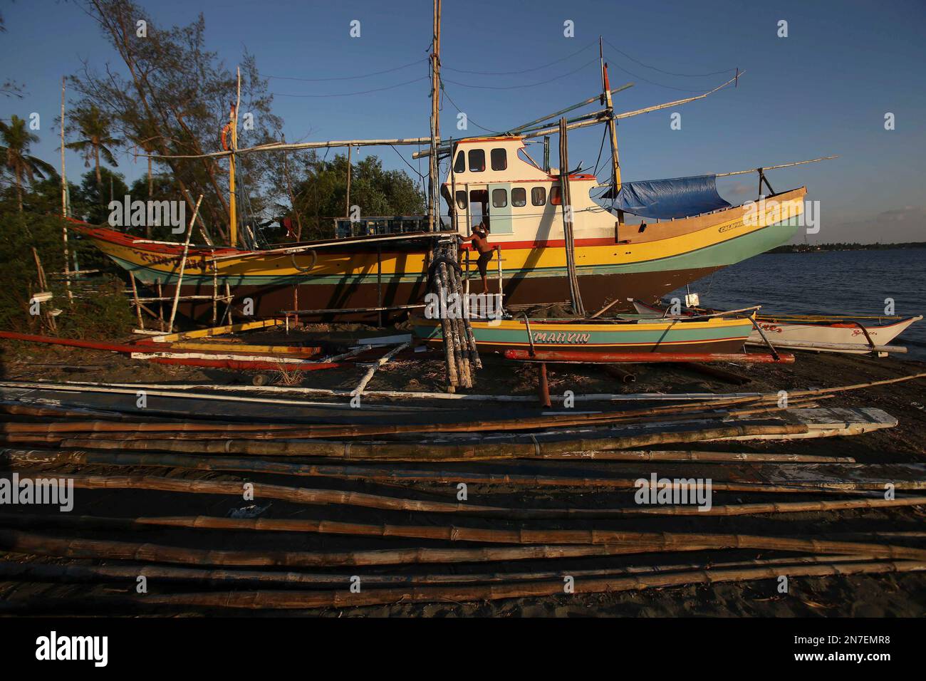 In this May 6, 2013 photo, a Filipino fisherman climbs up the Queen Kim ...