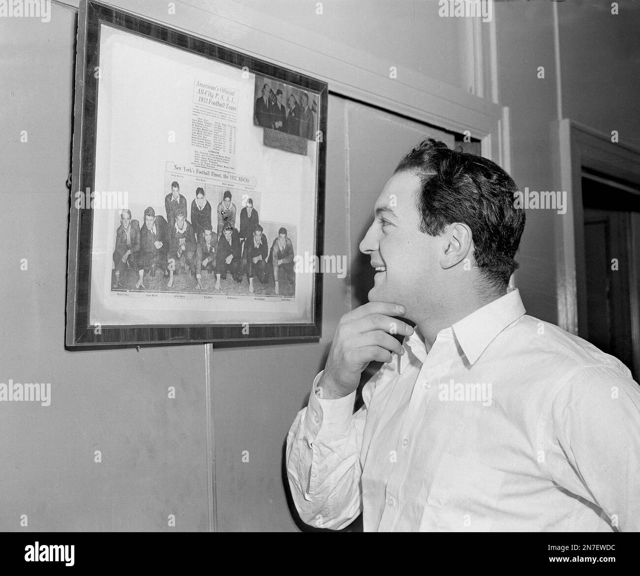 Sid Luckman of the Chicago Bears looks over an old photo of himself ...