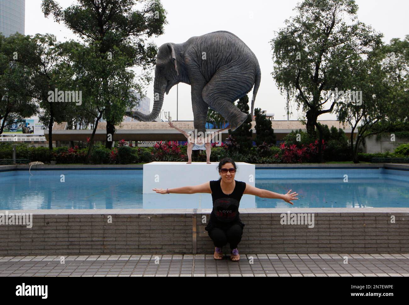 A woman poses for photos in front of a five meters high sculpture ...