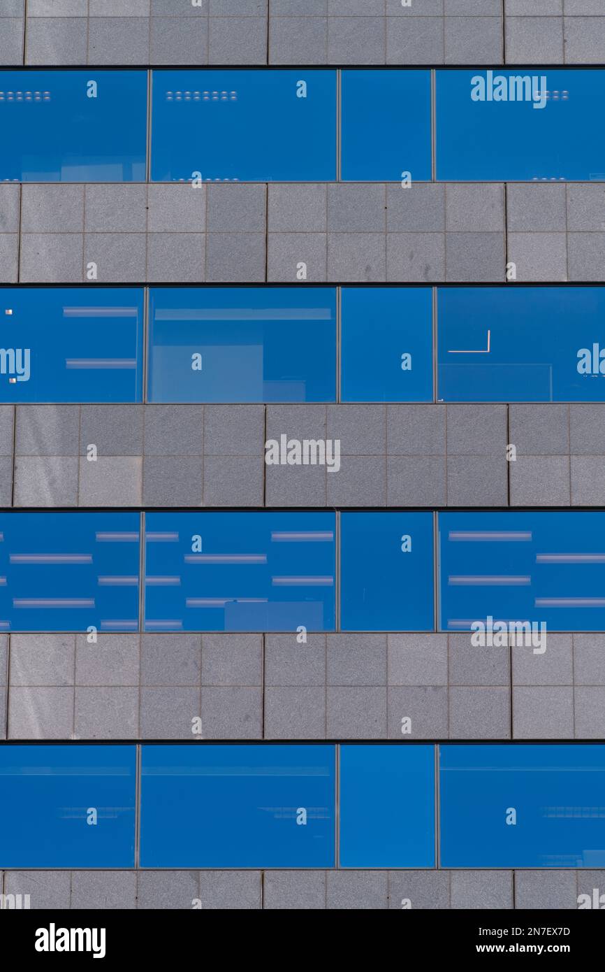 Glass office building abstract view showing office block close up, glass windows and internal ...