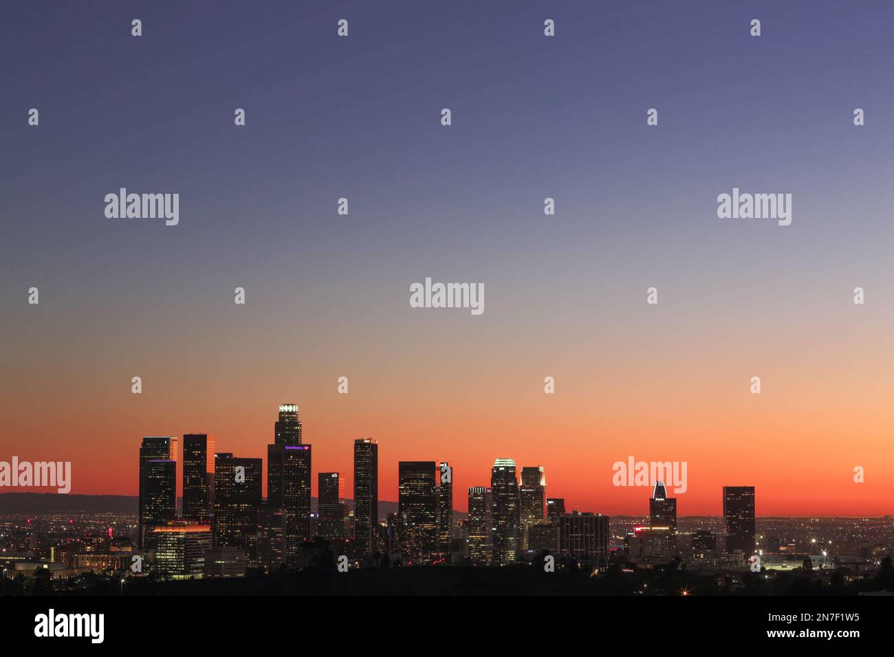 The sun has set and backlights a beautiful los angeles sky line during ...