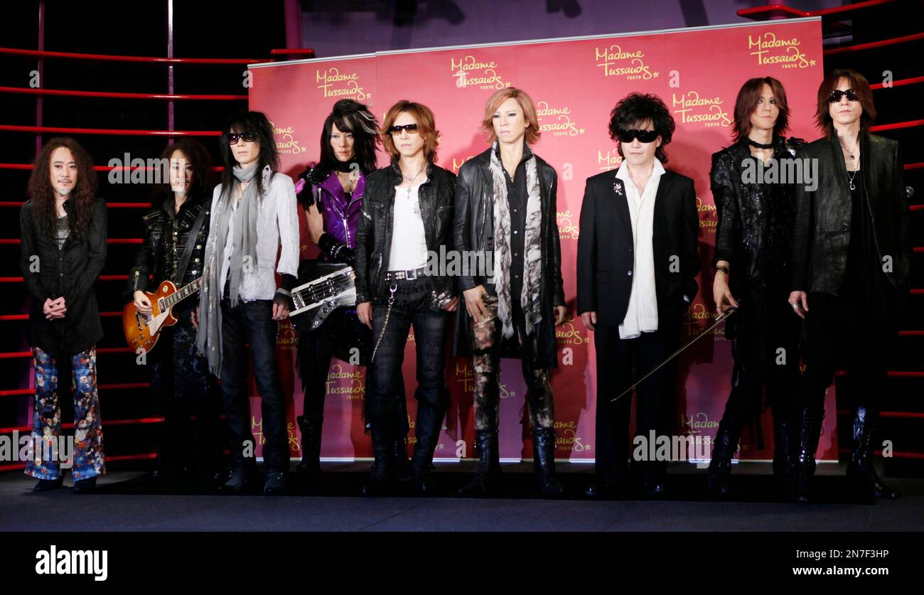 Japanese rock band X Japan's members pose with their wax figures during ...