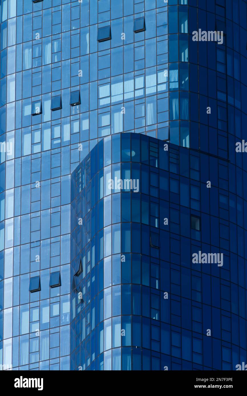 Glass office building exterior view with open and closed windows in ...