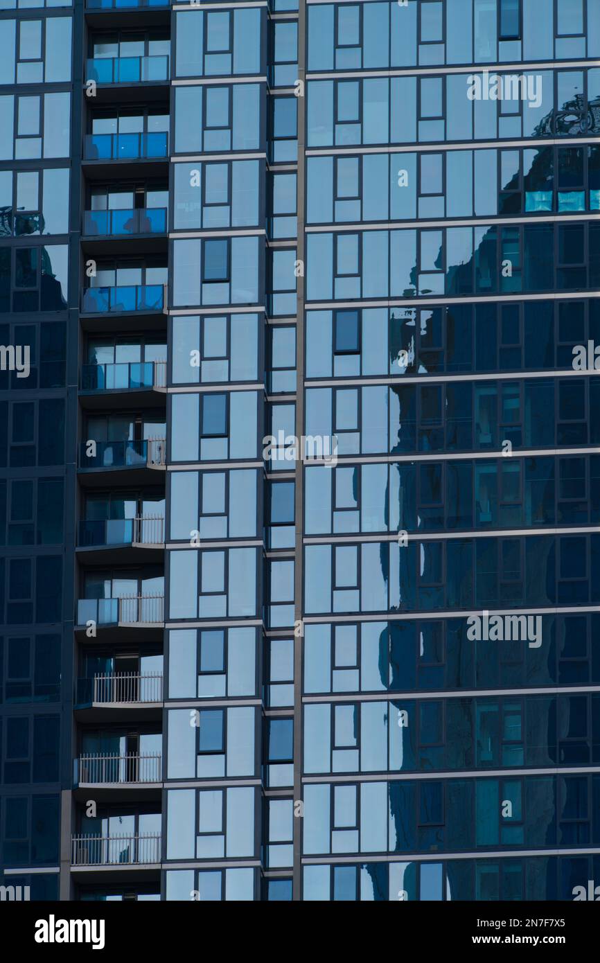 Modern city building apartment block with balconies, windows and glass ...