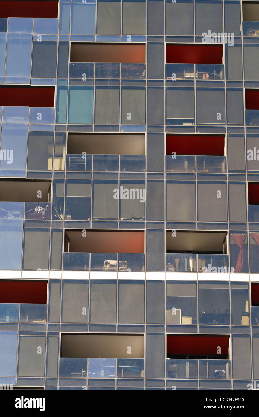 Apartment block exterior view showing building glass windows and small ...