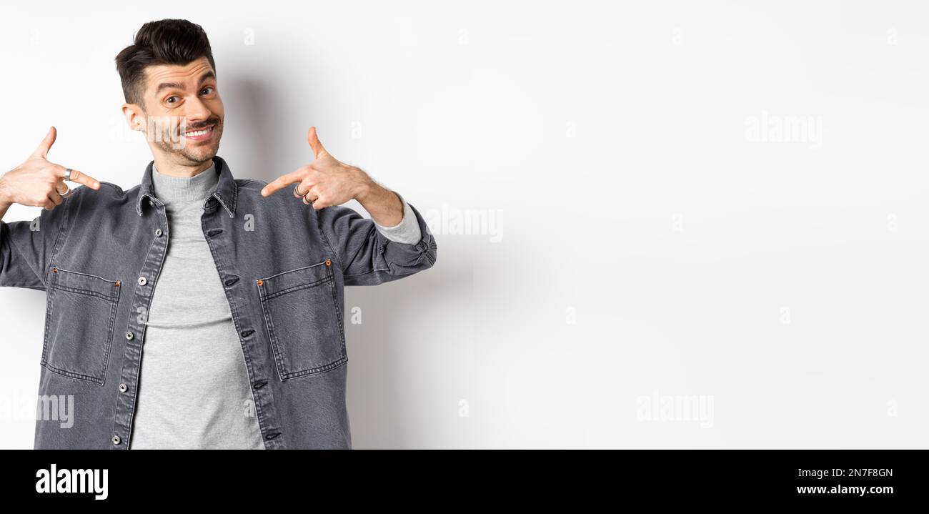 Handsome guy with moustache and white smile pointing fingers at center ...