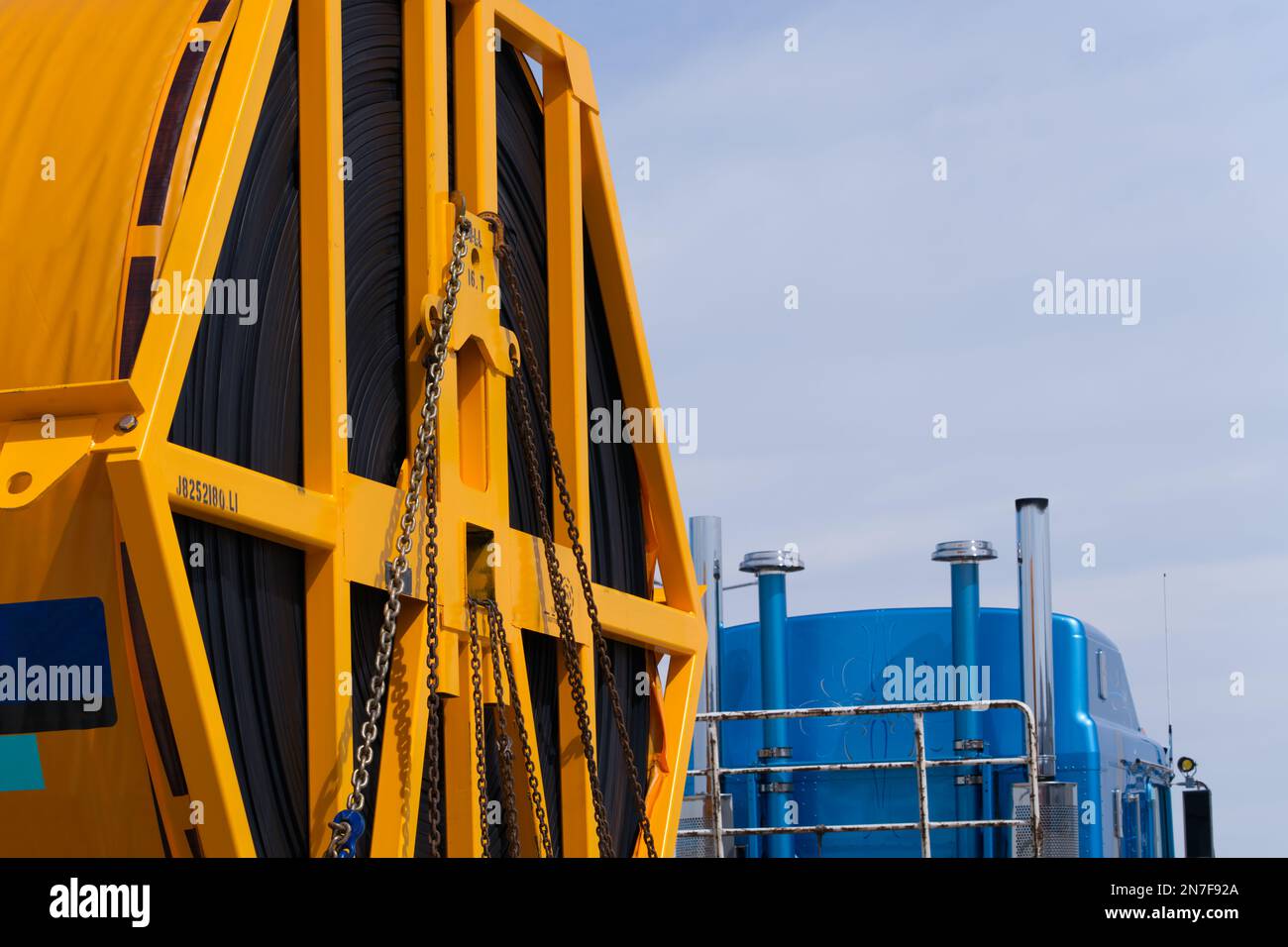 Truck carrying cargo and steel shipment in a yellow container with ...
