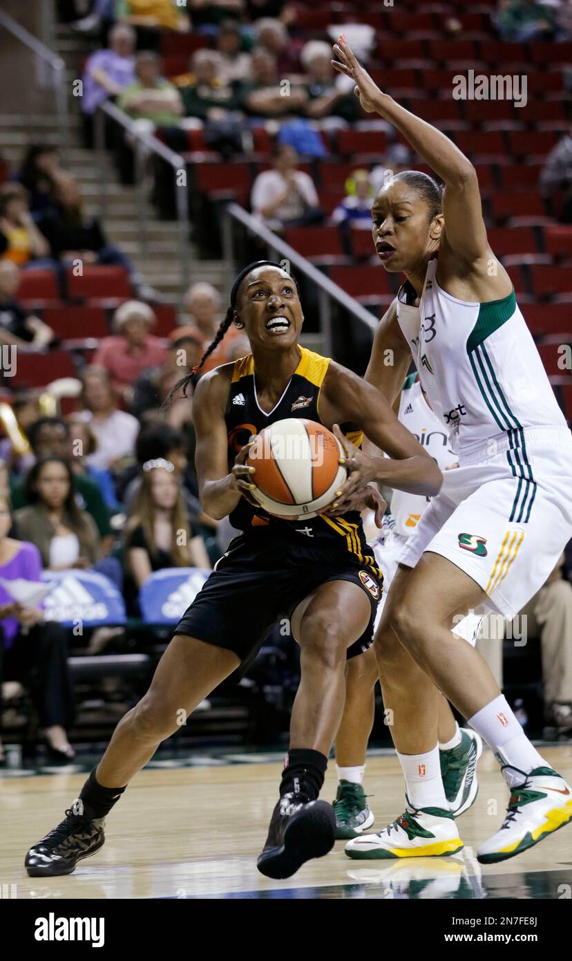 Tulsa Shock's Candice Wiggins, left, tries to drive past Seattle Storm ...