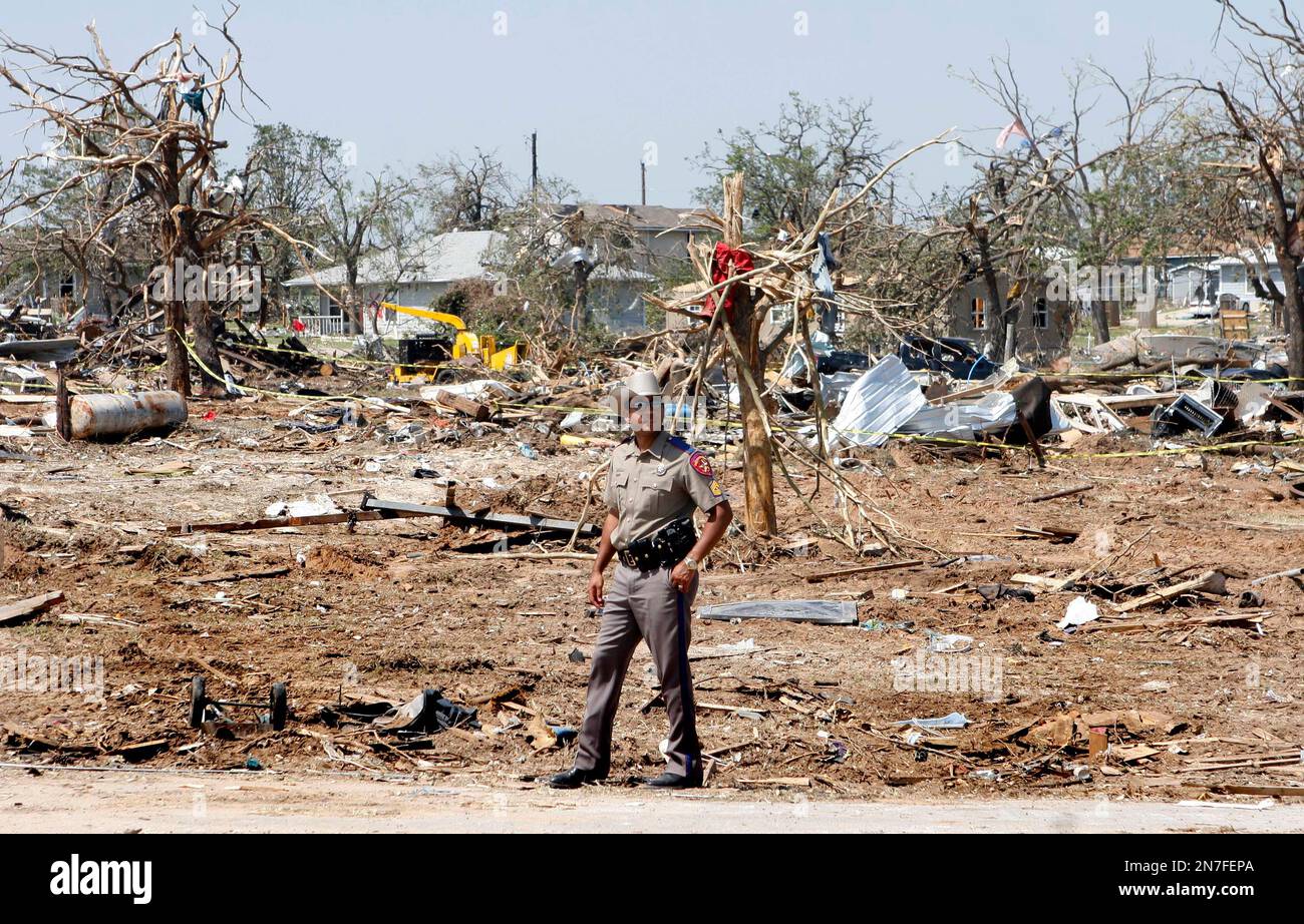 Texas State Trooper Sgt. Jeremy Sherrod walks through storm-damaged ...