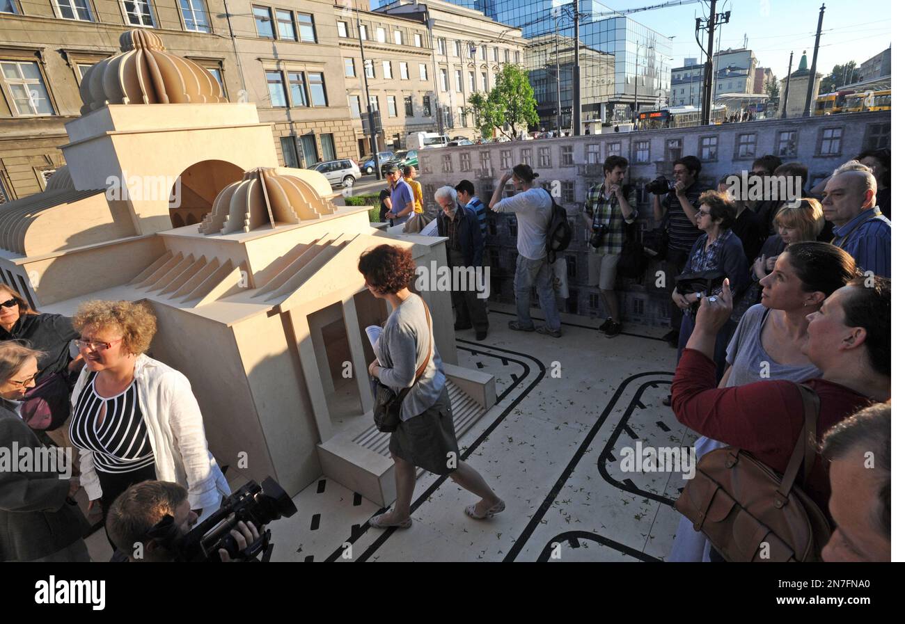 People look at a 1:10 scale model of the Great Synagogue of Warsaw and ...