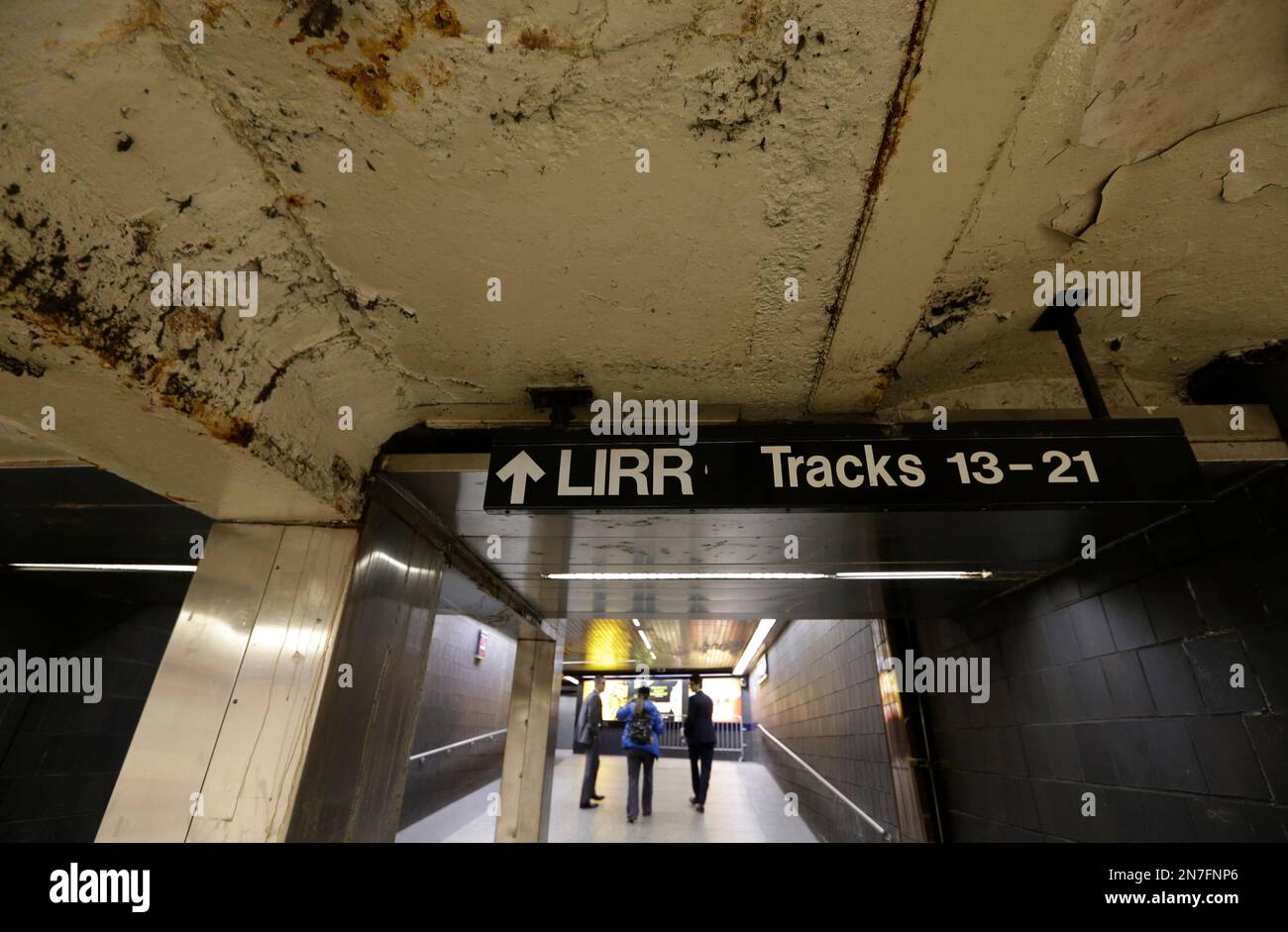 A water damaged and rusted ceiling is visible in a corridor leading to ...