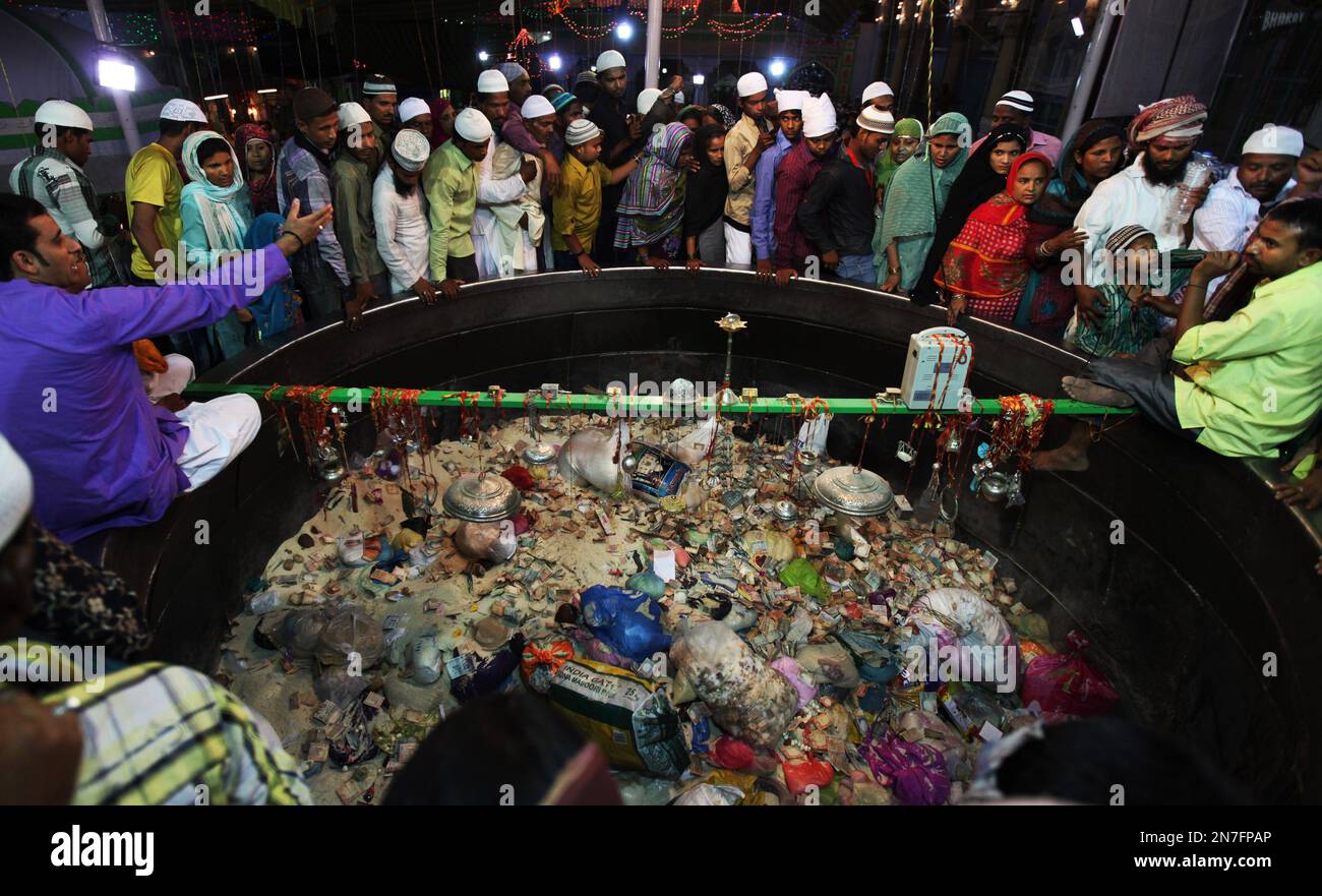 In this Wednesday, May 15, 2013 photo, Indian Muslim devotees walk past ...