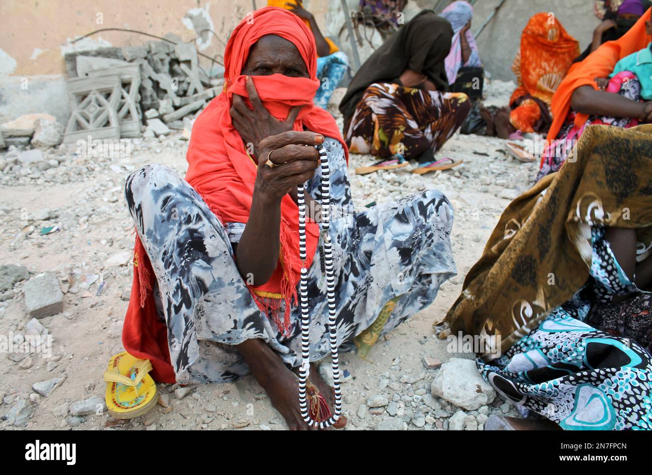 In this photo taken Friday, April 19, 2013, a Somali Sufi woman counts ...