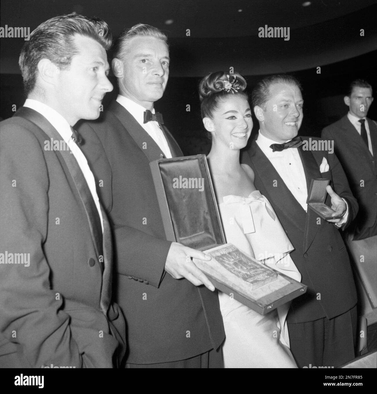 Three British men and Pier Angeli, the Italian actress, pose with two ...