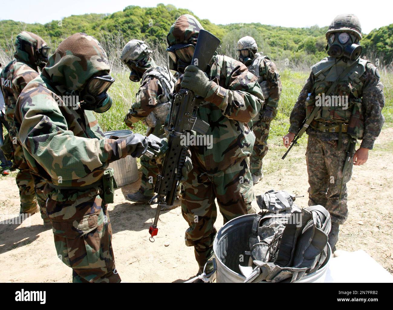 A U.S. Army soldier, left, checks the radiation level of the machine ...