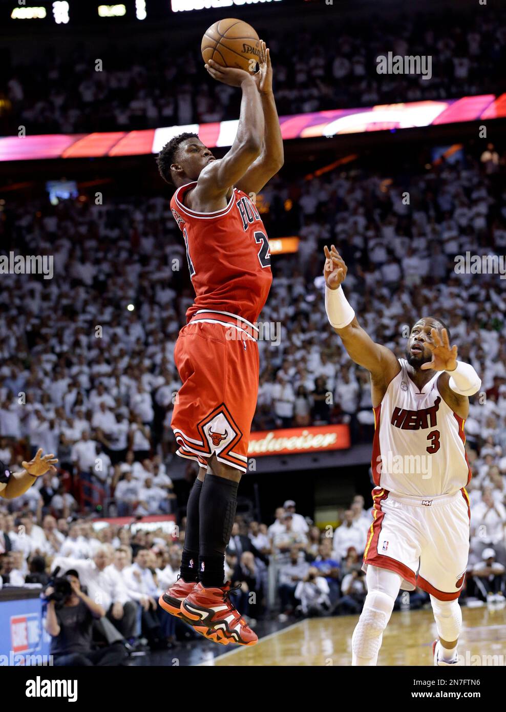 Chicago Bulls' Jimmy Butler, left, attempts a 3-pointer over Miami Heat's Dwyane Wade (3) in the ...