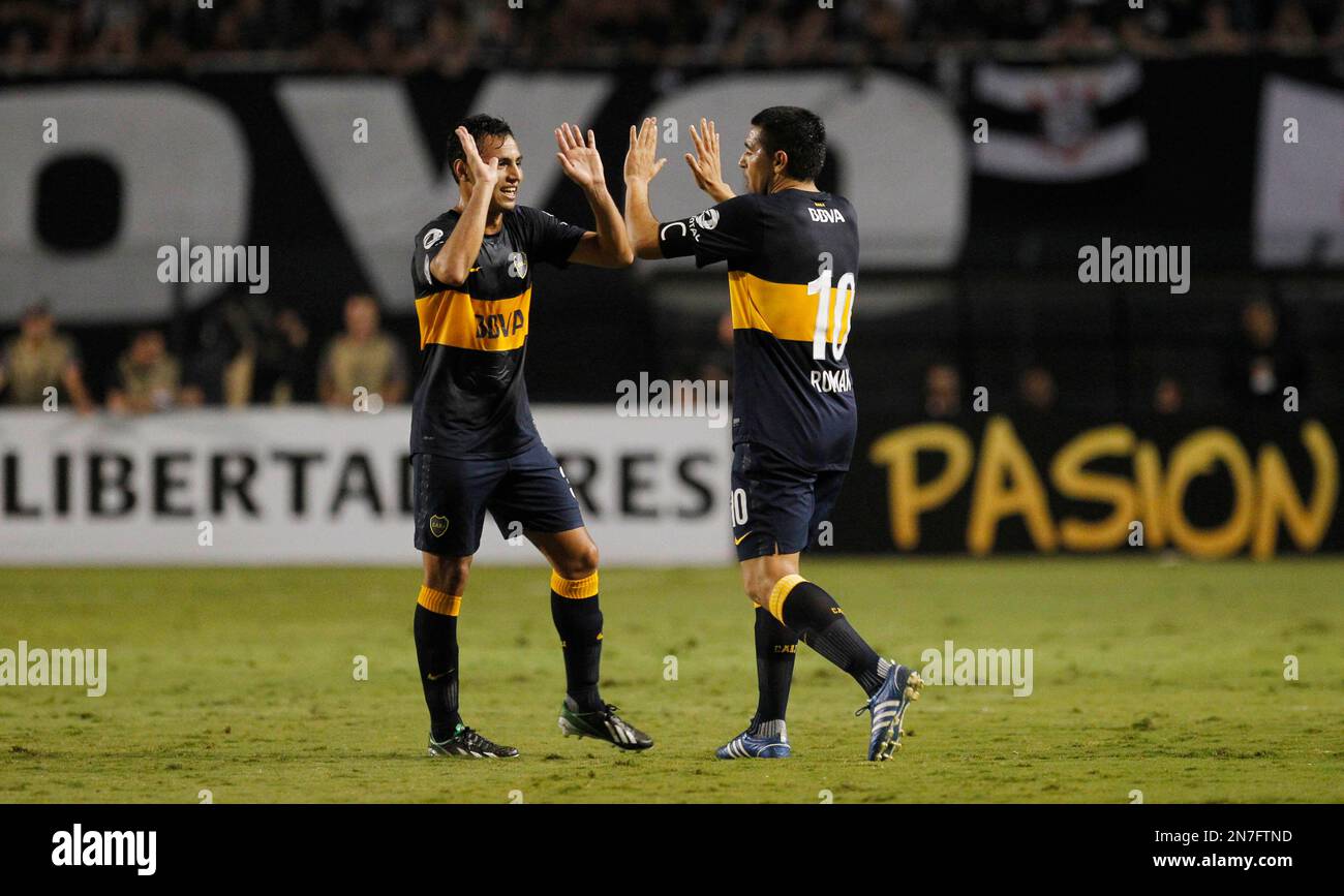 Roman Riquelme of Argentina's Boca Juniors, right, celebrates with his ...