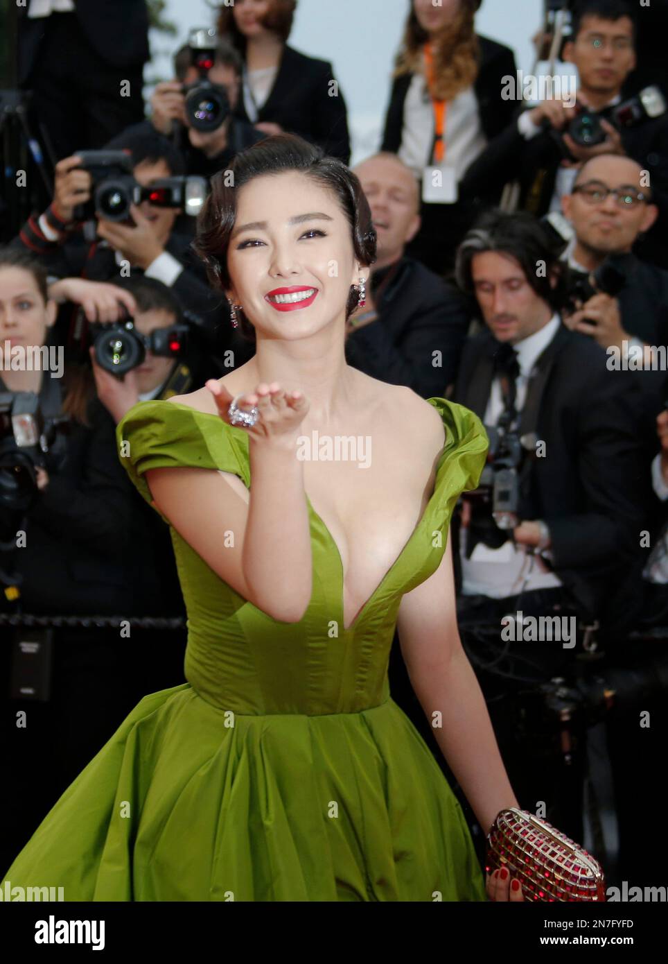 Actress Zhang Yuqi blows a kiss to photographers as she arrives for the opening ceremony and the ...