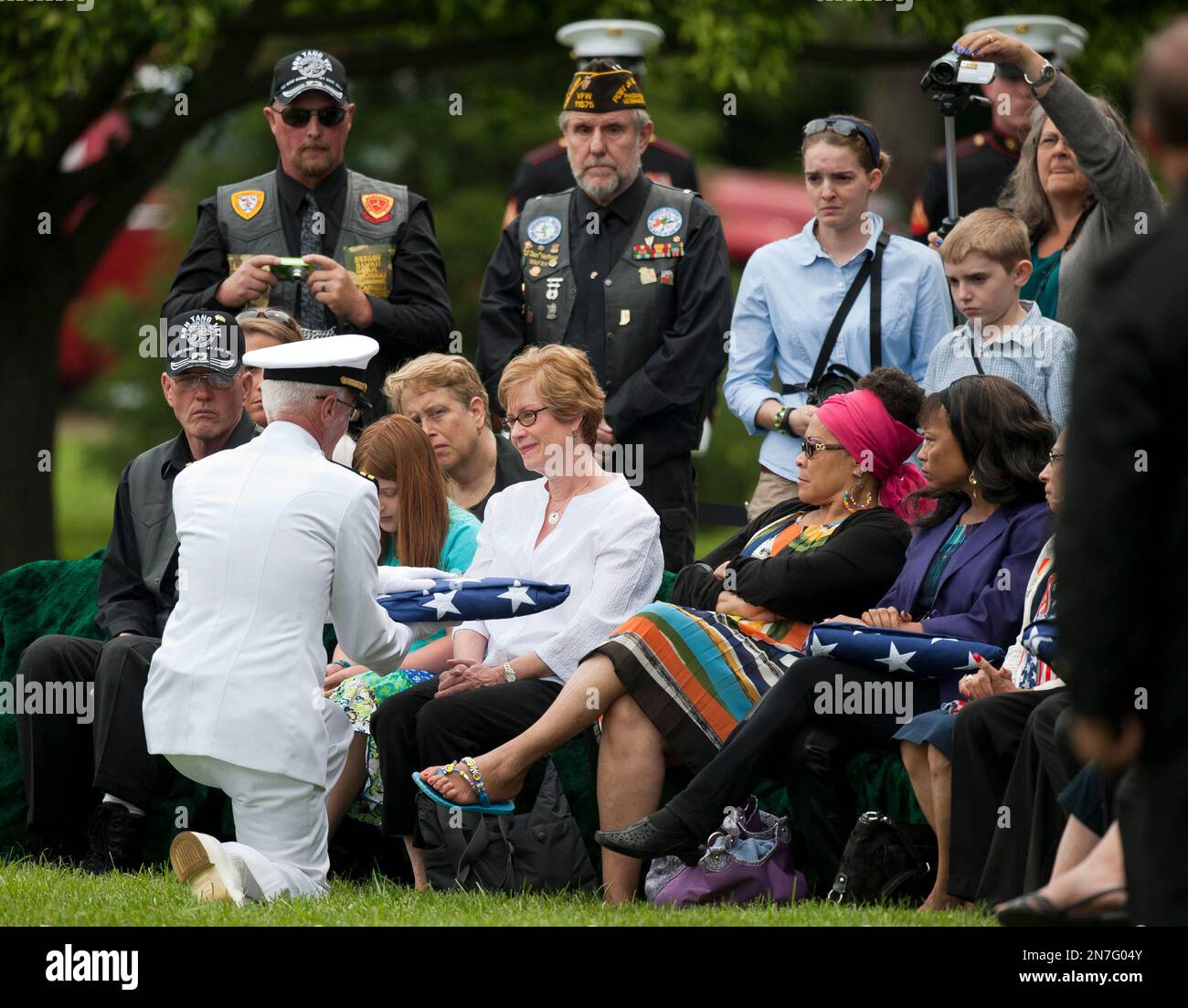 Navy Lt. Father Willaim Dorwat presents a U.S. flag to Henri Marcus ...