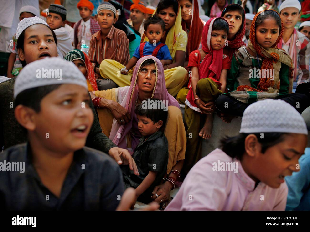 In this Monday, May 13, 2013 photo, Indian Muslim Sufi devotees watch a ...