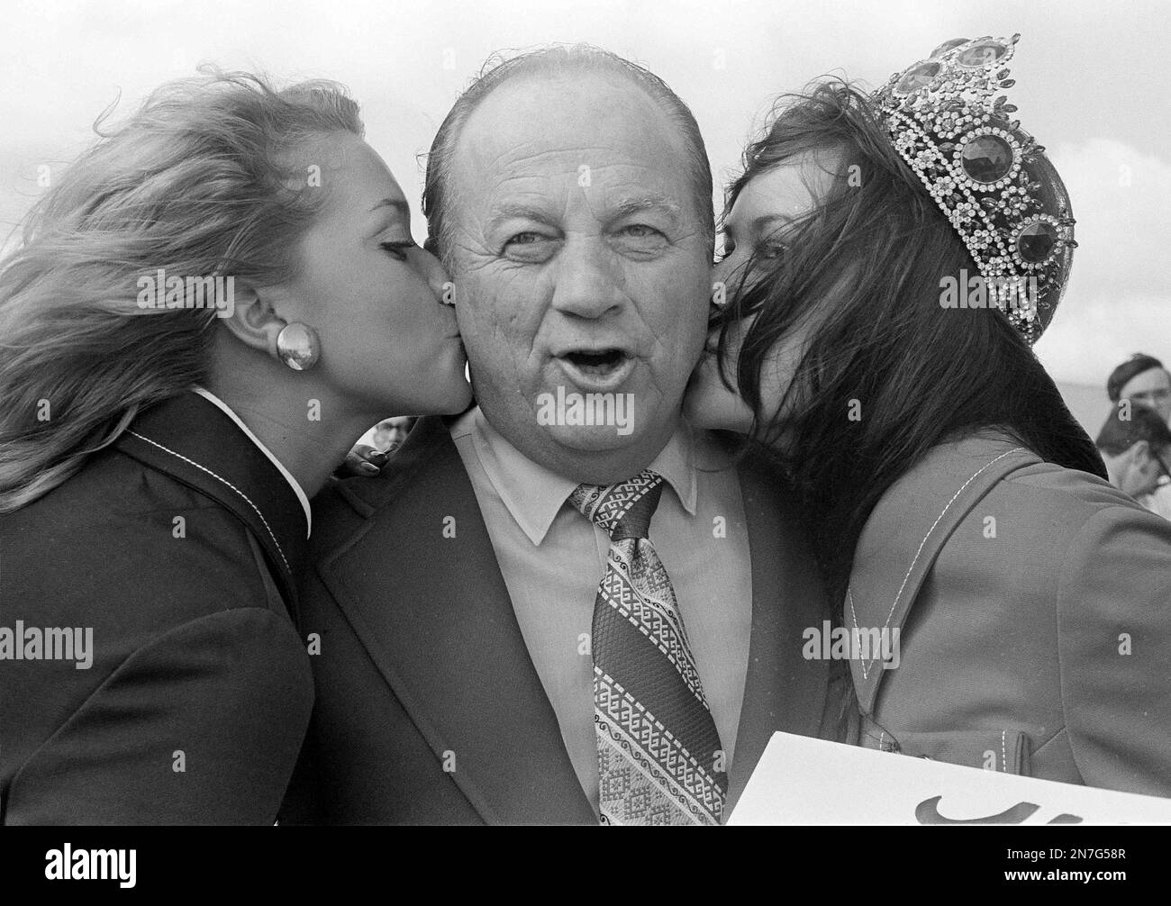 Nebraska football coach Bob Devaney happily collects kisses from Orange ...