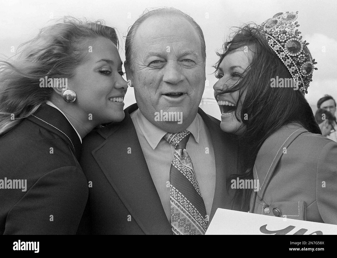 Nebraska football coach Bob Devaney happily collects kisses from Orange ...