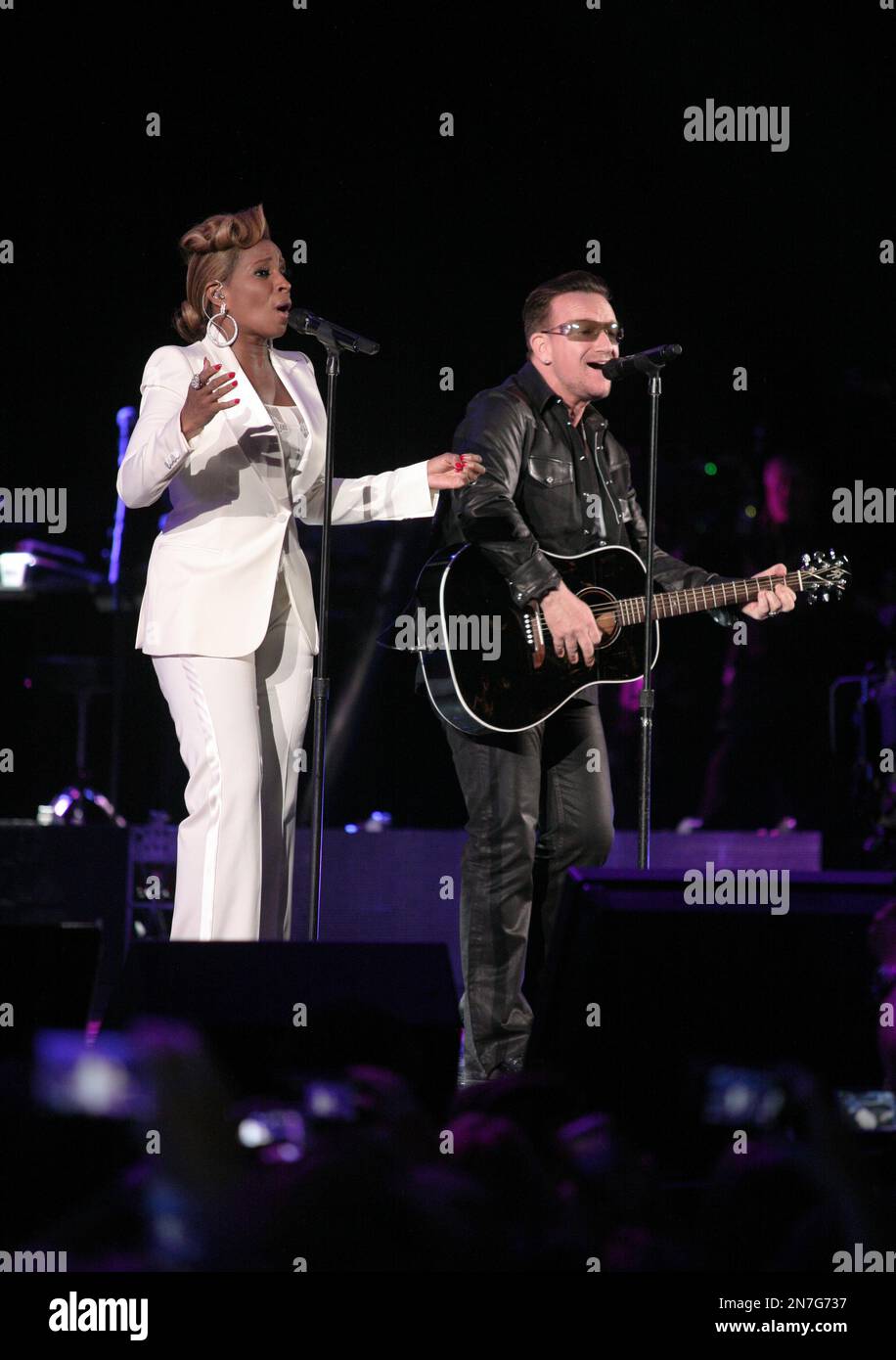 Musicians Mary J. Blige, left, and Bono, right, perform during the ...